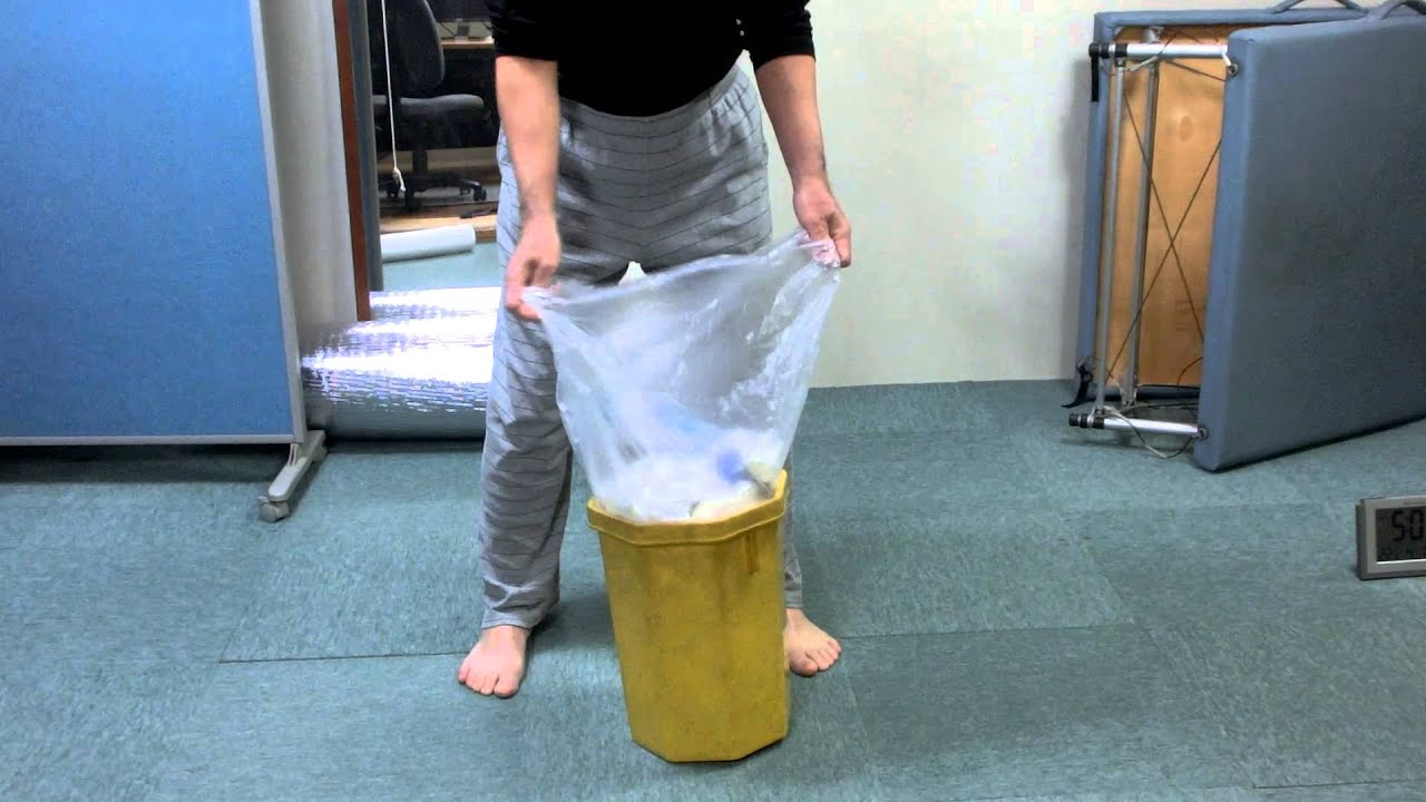 Ubiquitous Training Pull out plastic bag from waste basket by shaking ...