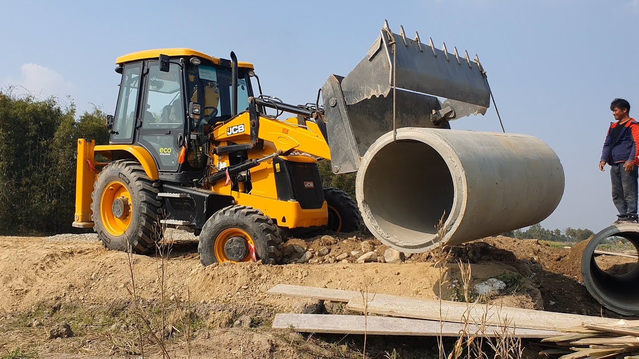 JCB Backhoe Loader Lifting Heavy Culvert Pipe and Installing in Drain ...