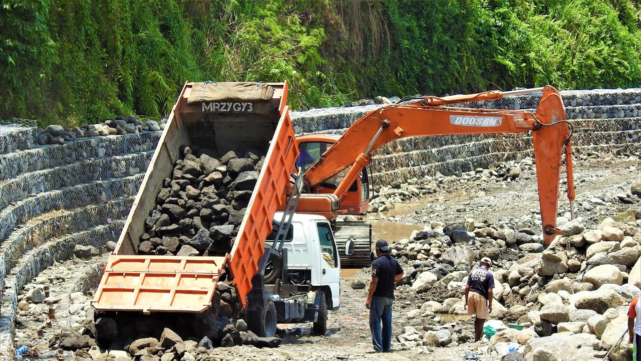 Excavator Trucks Working On The River Bank Reinforcement Construction ...