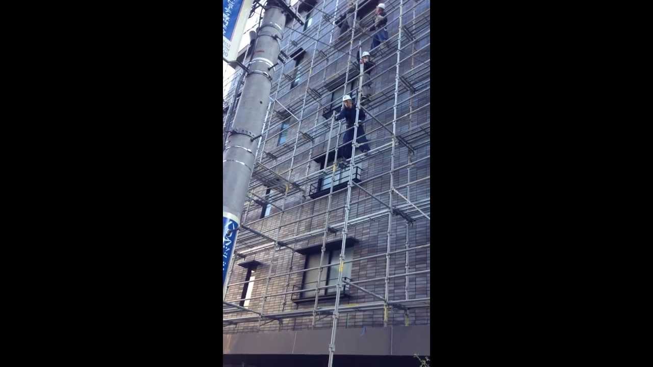 Japanese acrobatic construction workers pass heavy pipes like wooden ...