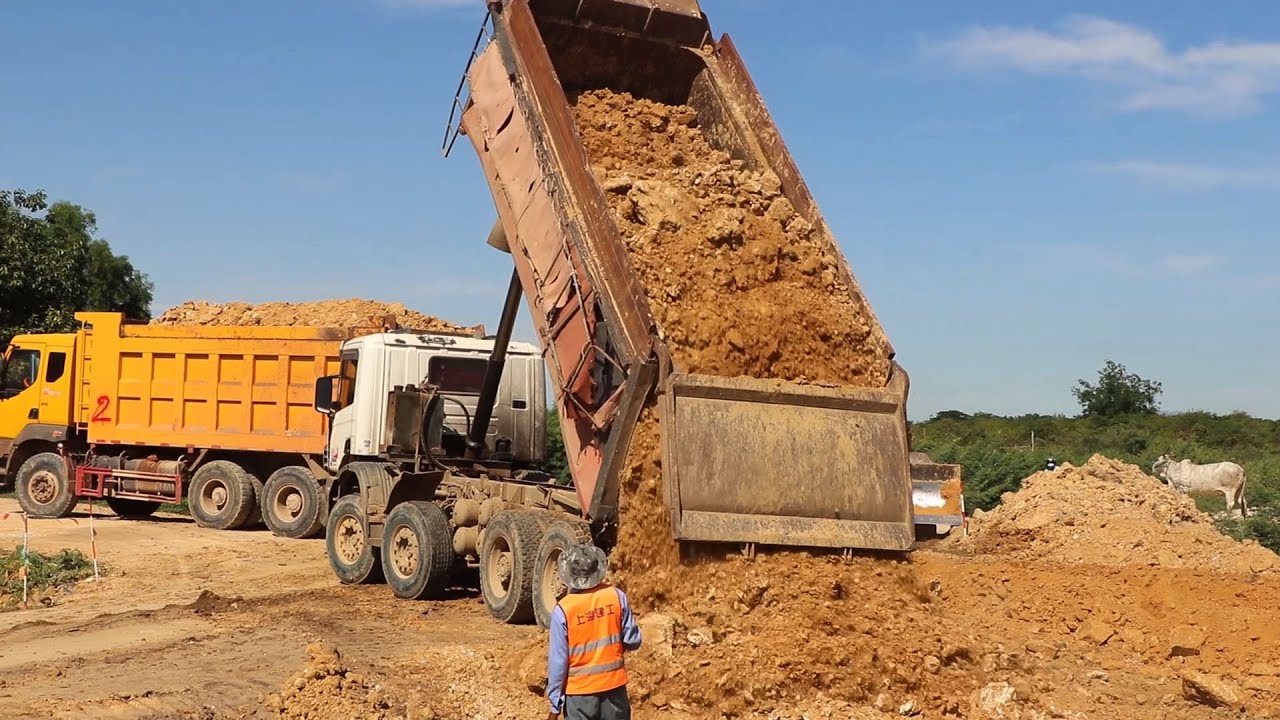 Great dump trucks working unloading soils - Incredible road ...