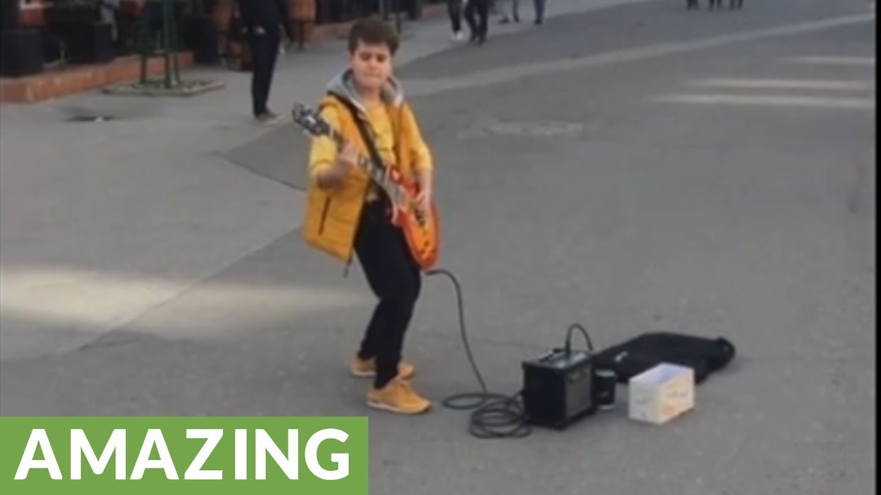 Street performing kid shreds classic 'Metallica' song on guitar - YouTube