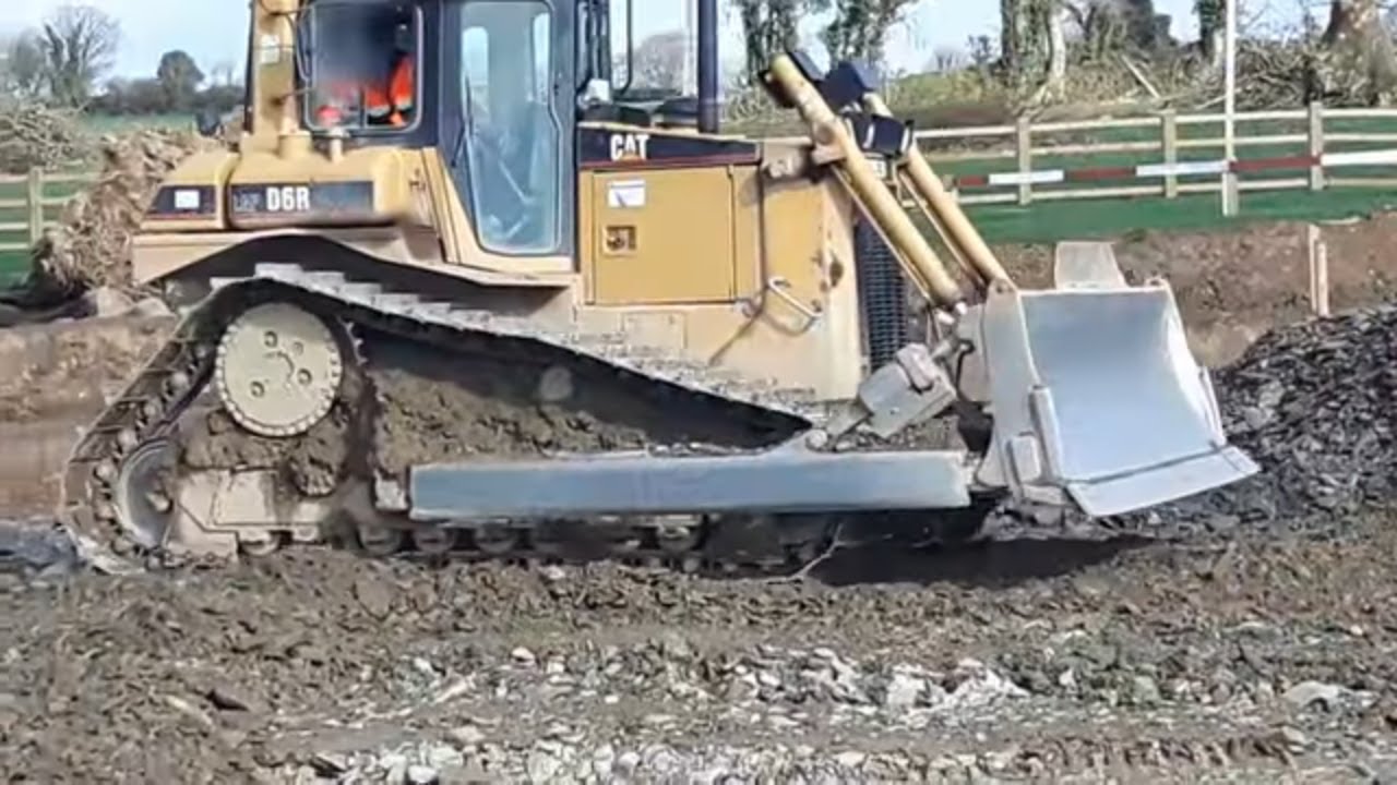 CAT D6 dozer at work levelling stone on a road construction site #1 ...