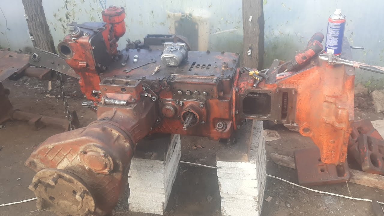An expert mechanic repairs a rusty tractor t25 that has been left in ...