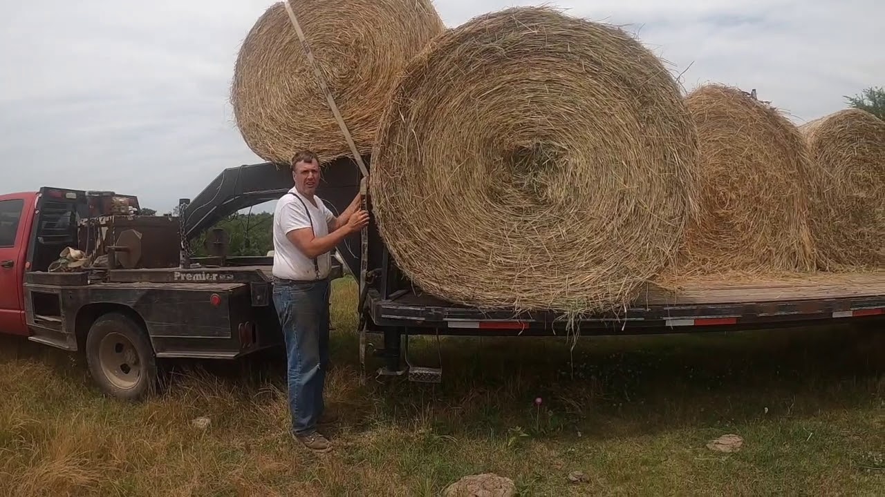how to unload round hay bales - YouTube