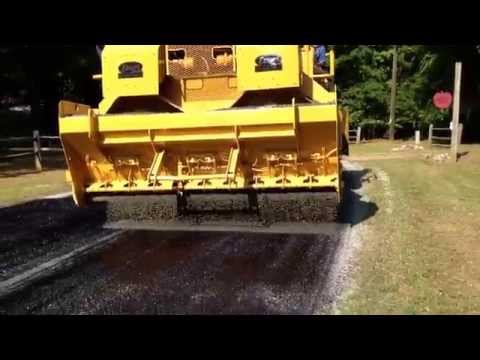 Tar and chipping a private road in Virginia done right 3rd layer