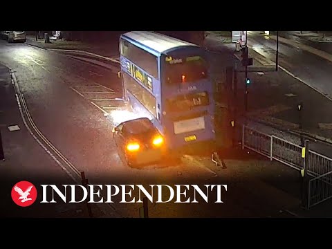 Moment speeding car collides with bus and causes it to crash into house ...