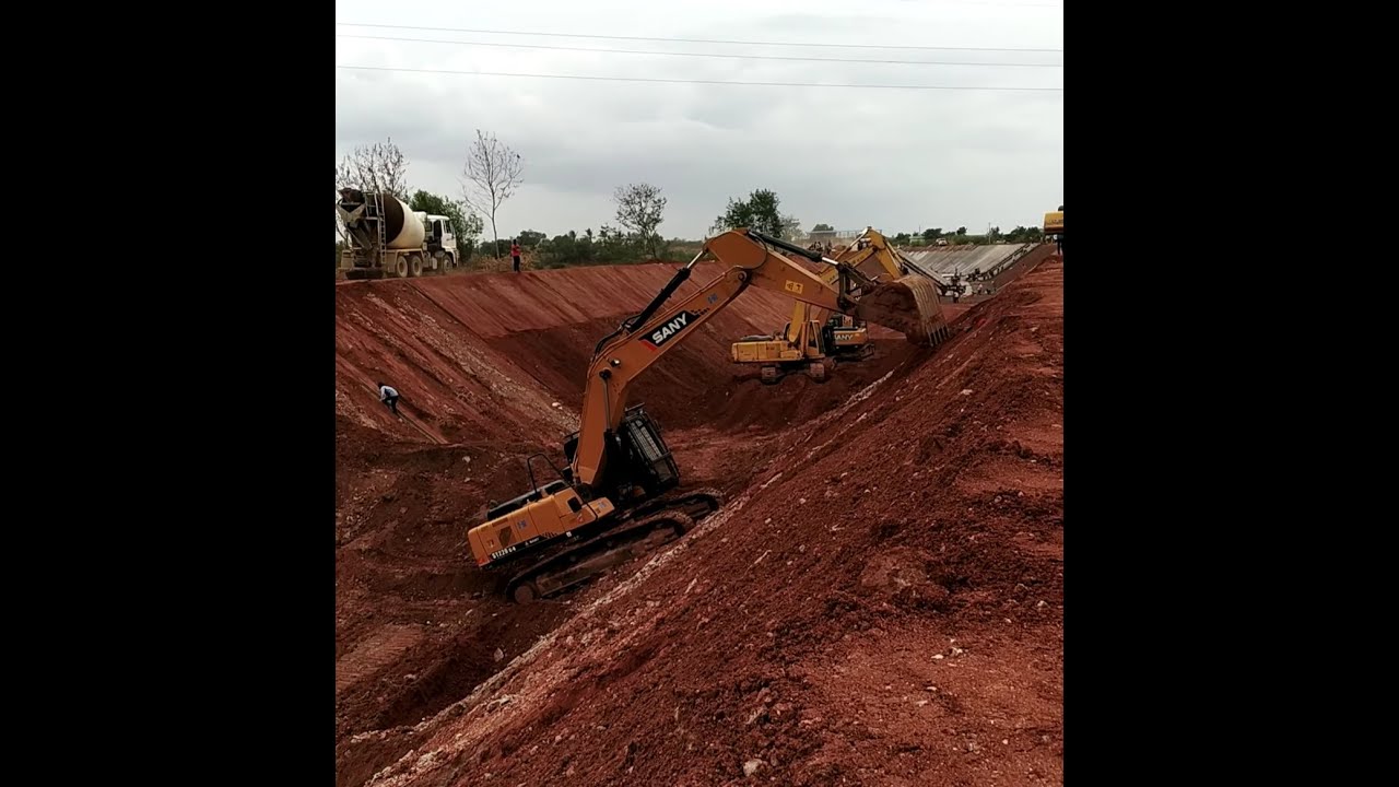 Civil engineering,canal work, trimming work at main canal by machines ...