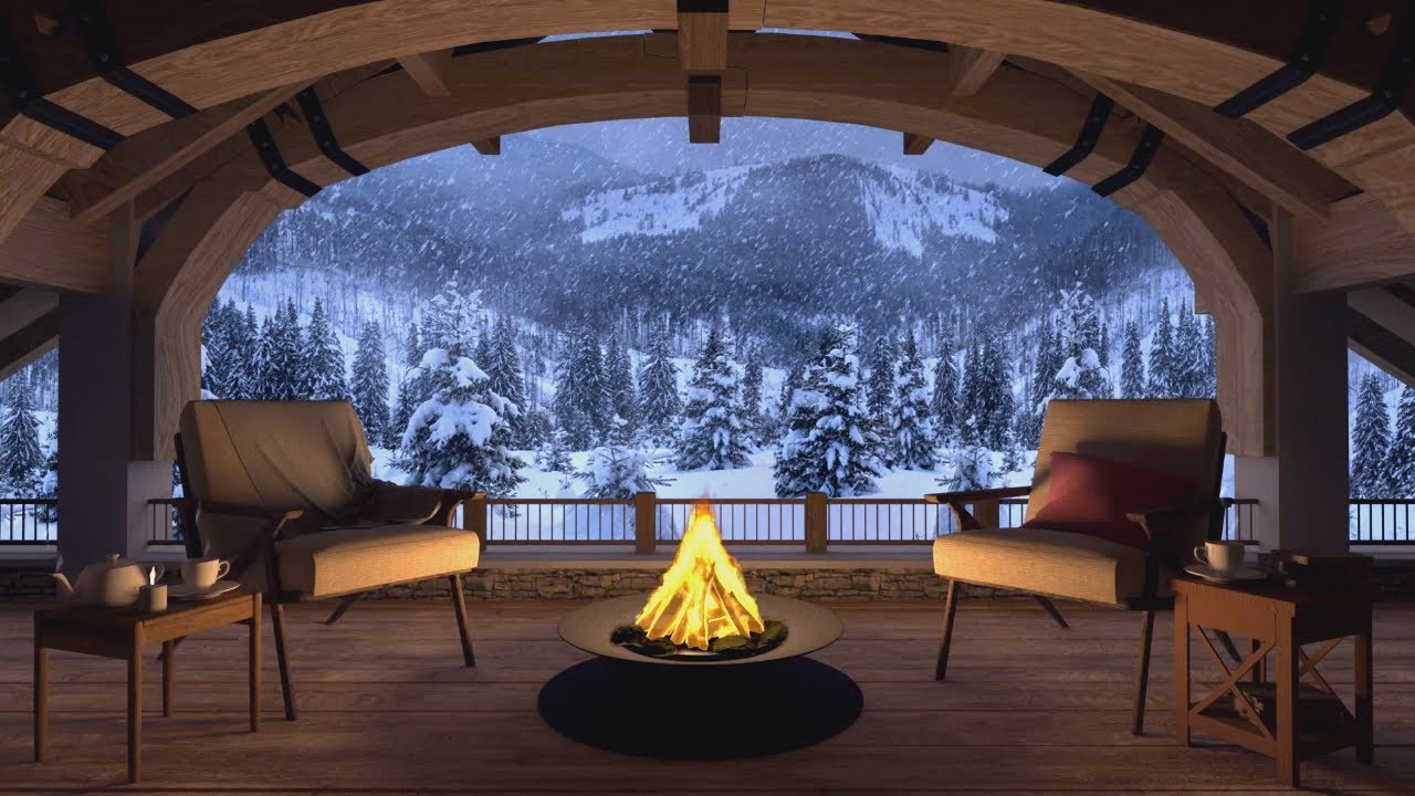 Winter cozy veranda in the mountains with a fire, falling snow and the ...