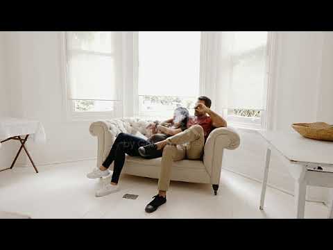Pregnant Woman On Sofa With Husband Smoking Ecigarette Stock Video   Download Video Clip Now   iStoc