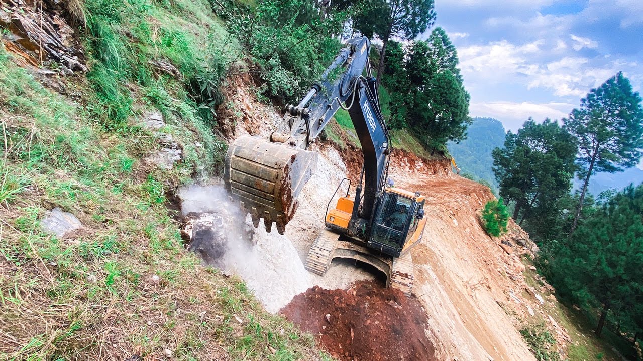 Watch This Excavator Build a New Track Up a Mountain | Excavator Planet ...