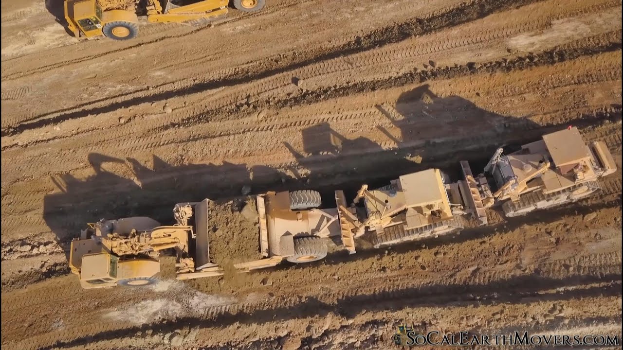 Double pushing CAT 651E and 651B scrapers with D10N dozers - YouTube