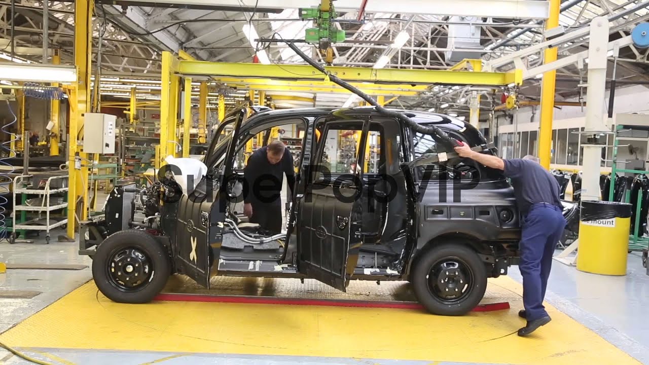 Wide Shot, Workers inside the factory of The London Taxi ... - YouTube
