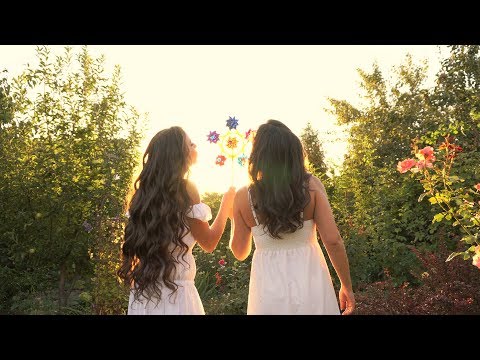 Sisters blow a toy pinwheel - YouTube