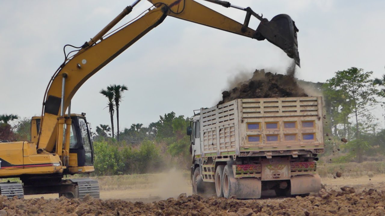 Machines Dirt Loading Into Dump Trucks Operating With Volvo Komatsu ...