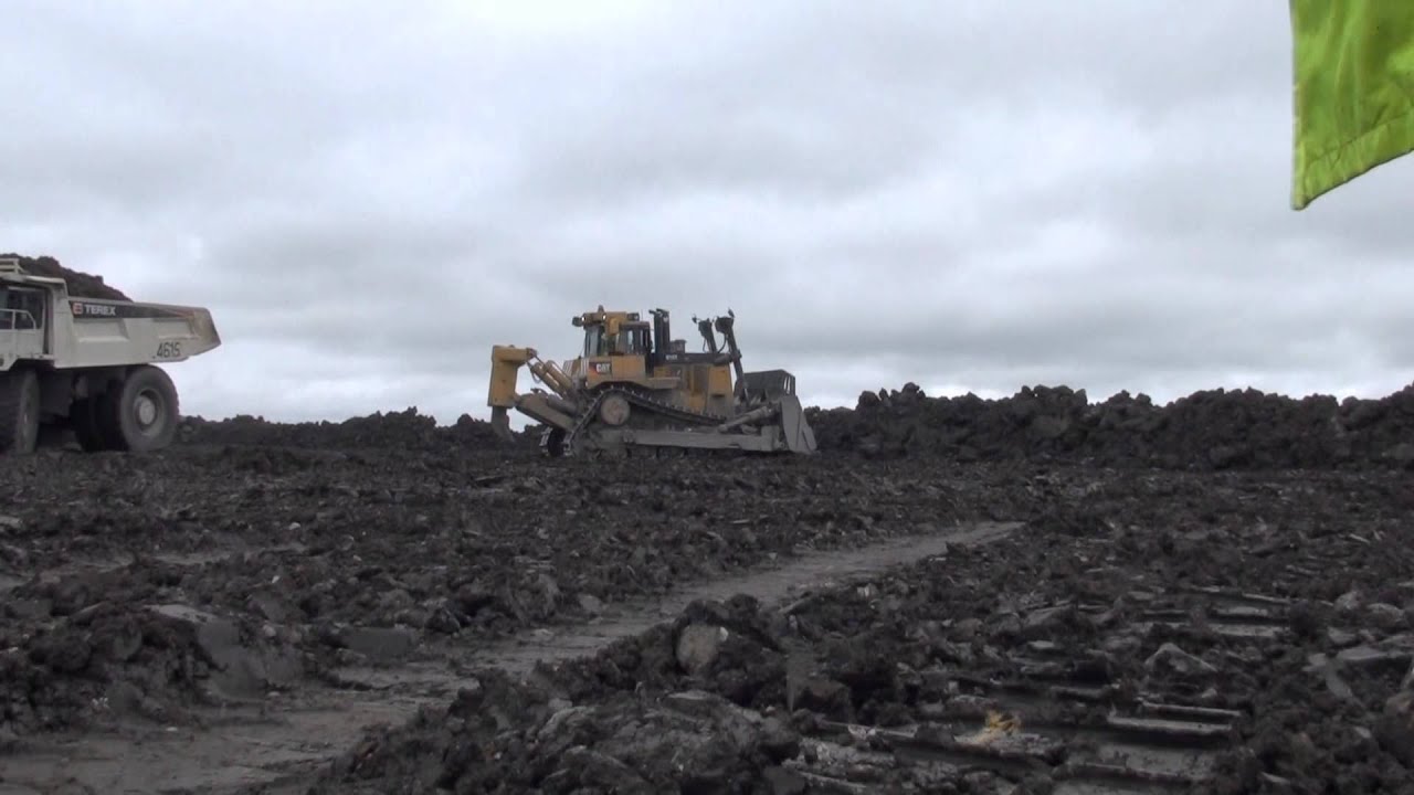 Caterpillar D10T dozer and Caterpillar 785D trucks on the waste tip ...