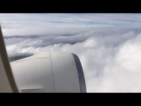 Real plane flying descending down through cloud layers... - YouTube