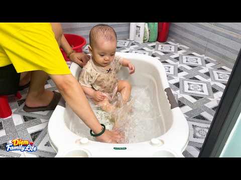 Baby Kim giggled with delight as played in the water for the first time