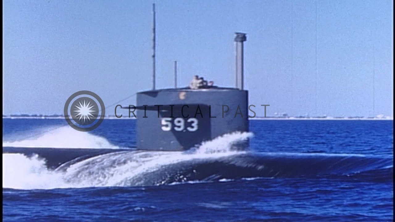 The USS Thresher underway begins to submerge under water with shoreline ...
