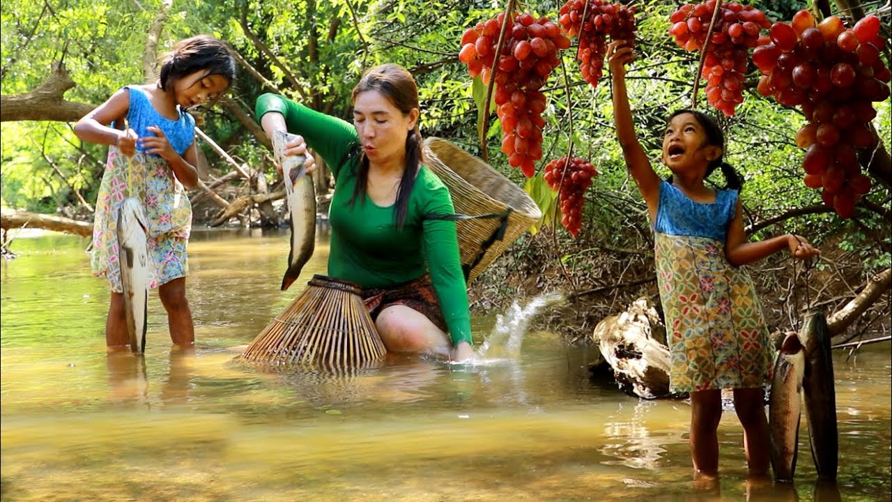 Mother with daughter net fishing for food- Grilled fish eating ...