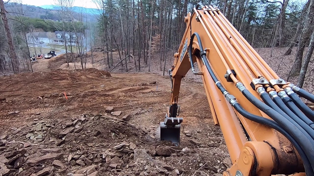 Excavator digging out shale rock at building site CX55B - YouTube