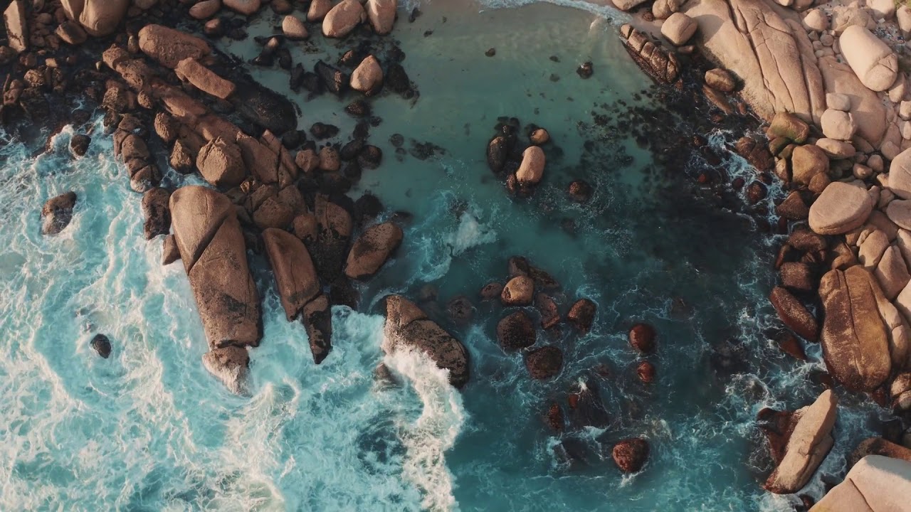 Drone footage of big rocks on the seashore - YouTube
