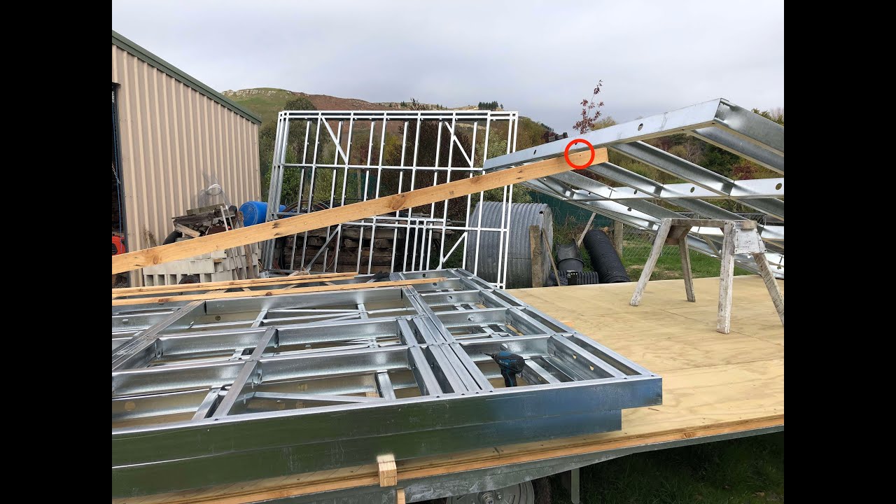 Standing the first frame with temporary brace attached - YouTube