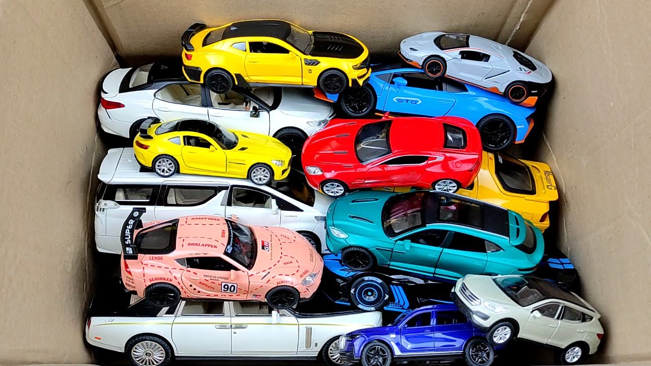 Box full of various miniature cars Rolls Royce, Aston Martin, Toyota ...