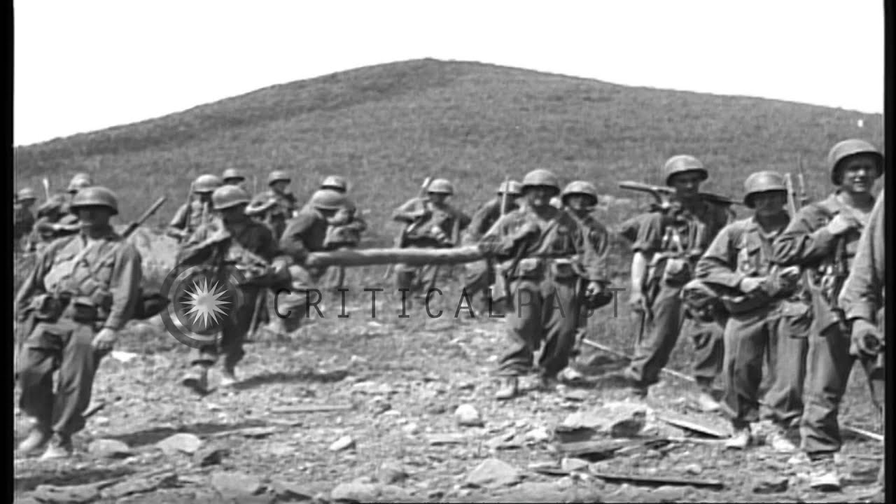 US 88th Infantry Division, advances along a mine-cleared, taped path ...