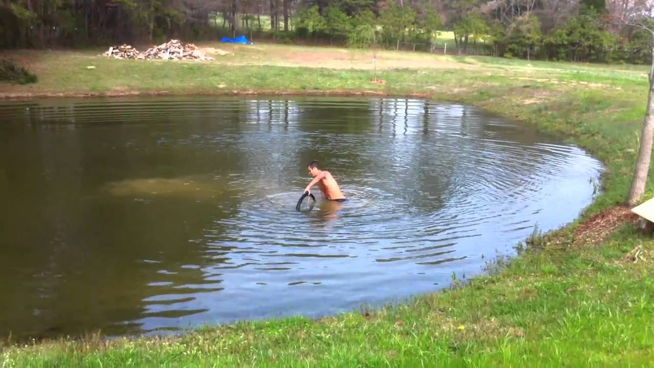 Devin jumping bike into pond - YouTube