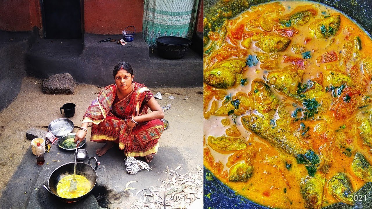 Santal tribe woman making fish curry in village style। Hako utu ...