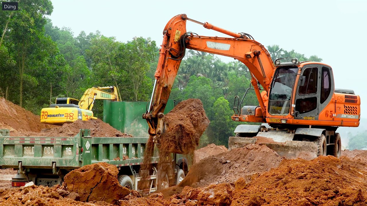 Heavy Wheel Loader Loading Soil On Trucks on Construction Site - JCB ...