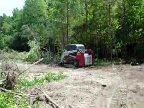 Skid steer pushing over trees - YouTube