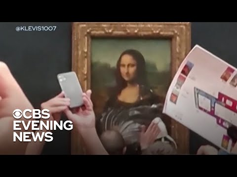 Man throws cake at Mona Lisa painting