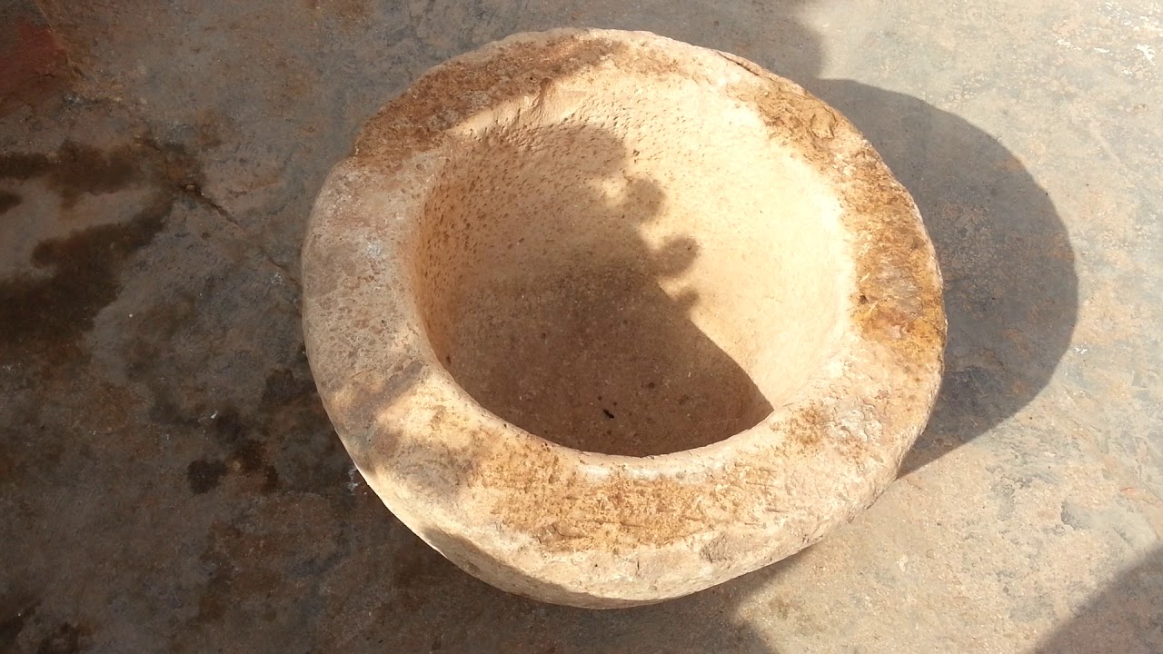 A hundred years old stone mortar - YouTube