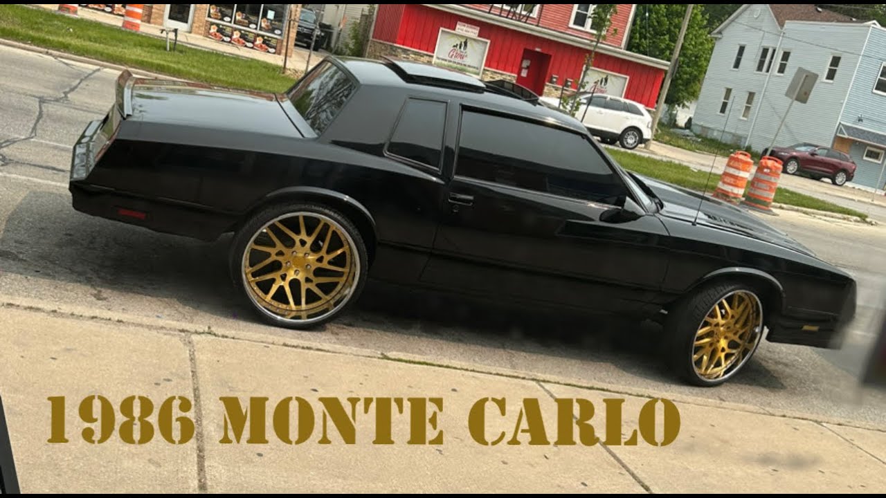PULLED UP ON A TINTED BLACK ON BLACK 1986 MONTE CARLO WITH 24INCH GOLD ...