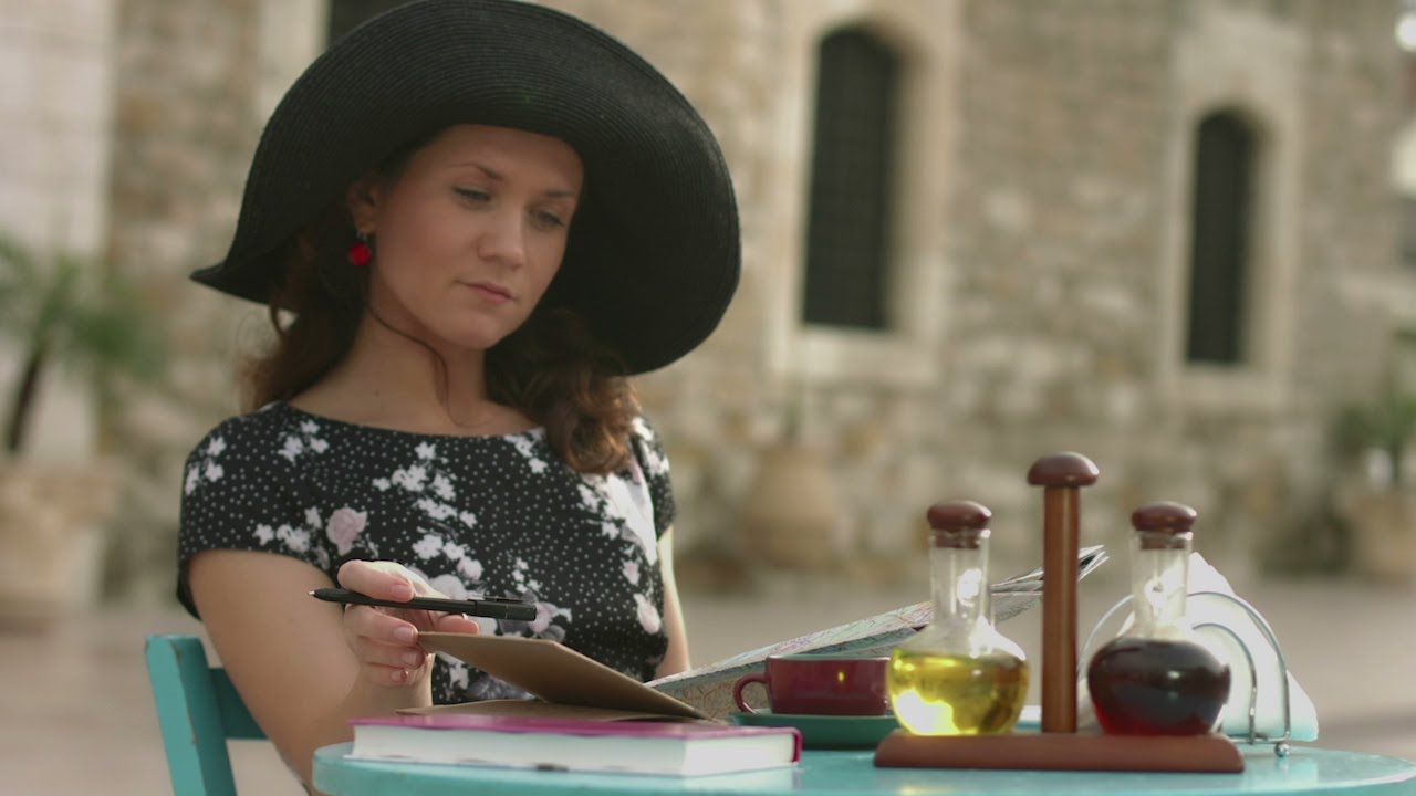 Young woman traveling abroad, planning trip with map in hands ...