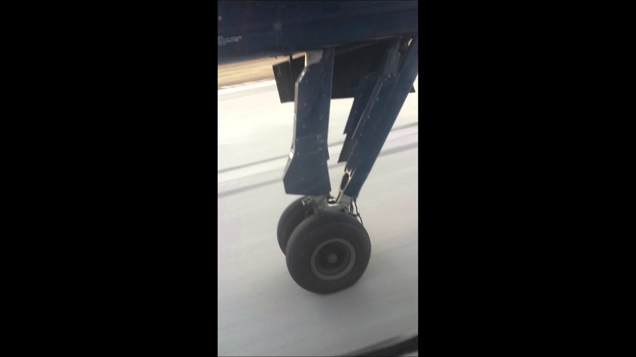 Airplane wheel going down runway during takeoff - YouTube