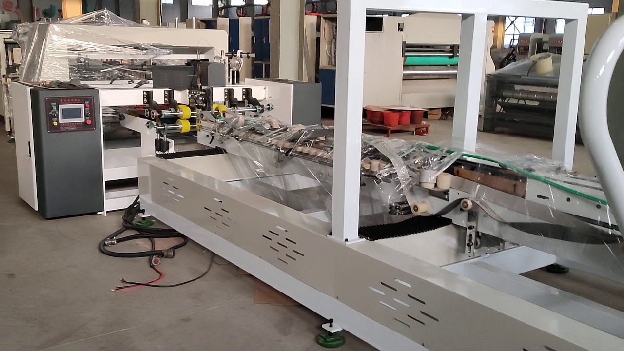 automatic carton folding gluing stitching strapping machine. - YouTube