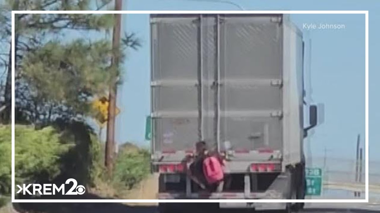 Video catches moment man hangs onto the back of a moving semi-truck ...