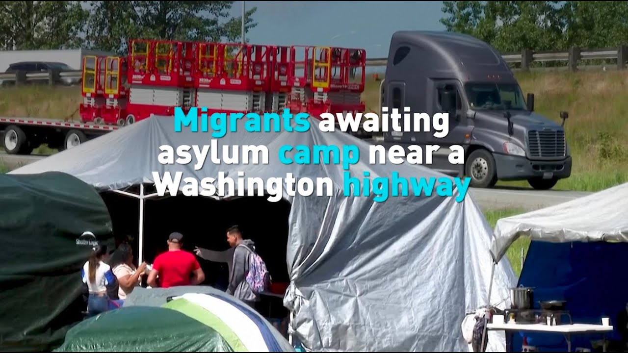 Migrants awaiting asylum camp near Washington highway - YouTube