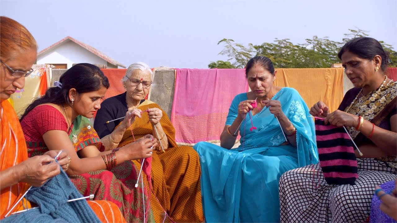 Group of an Indian women knitting winter clothes - Self Help G ...