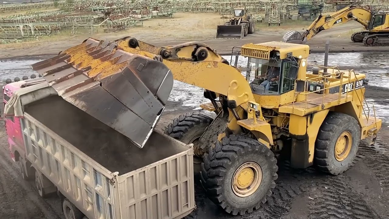 Caterpillar 990 Wheel Loader Loading Coal On Mercedes And Man Trucks ...