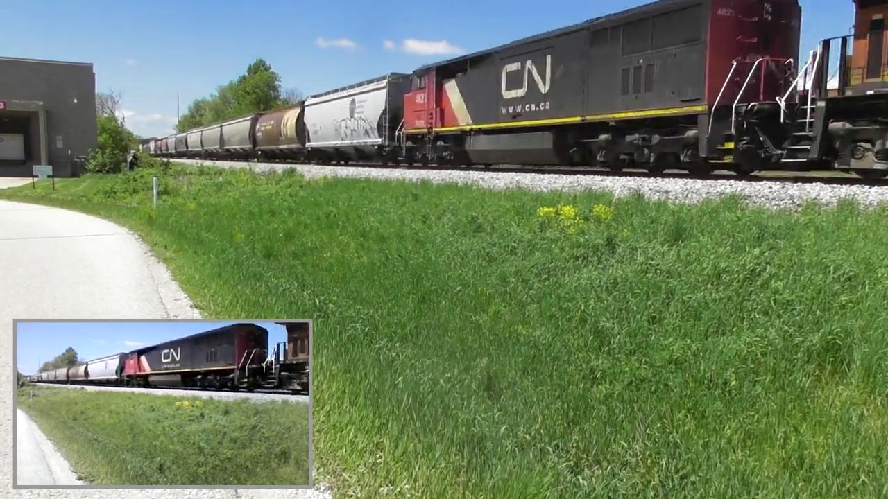 BNSF 7184 leads an eastbound grain train thru Duplainville on the ...