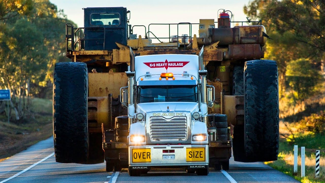 Australian Mack Titans trucks hauling oversize load Cat 793C mining ...