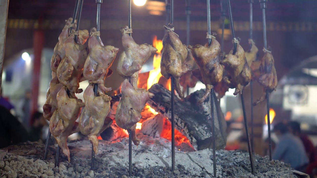 Traditional Indian, Pakistani sajji chicken being prepared on coal and ...