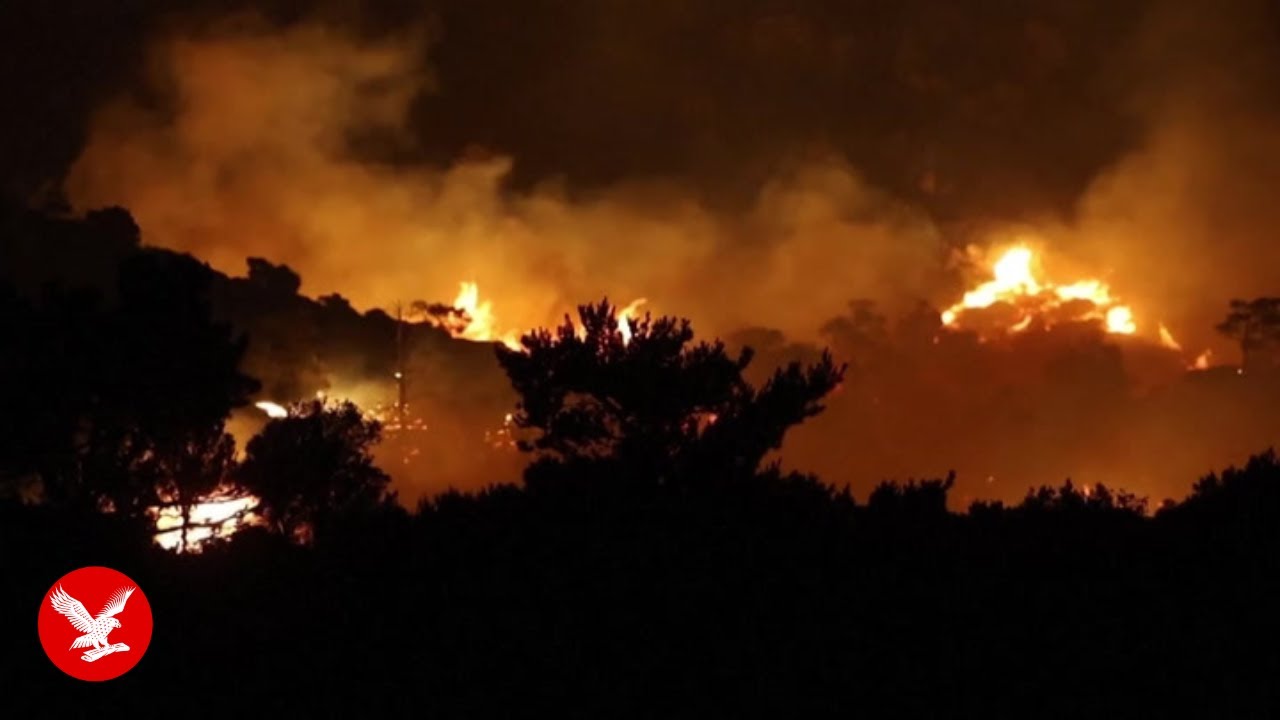 Thousands evacuated as massive wildfire rips through Greek island of ...