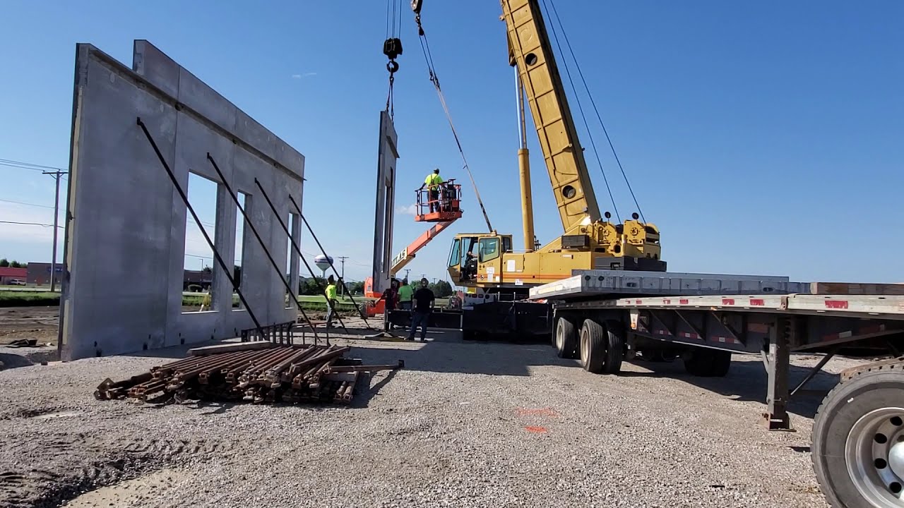 Crane lifting precast panels with thin brick trailhead construction pro ...
