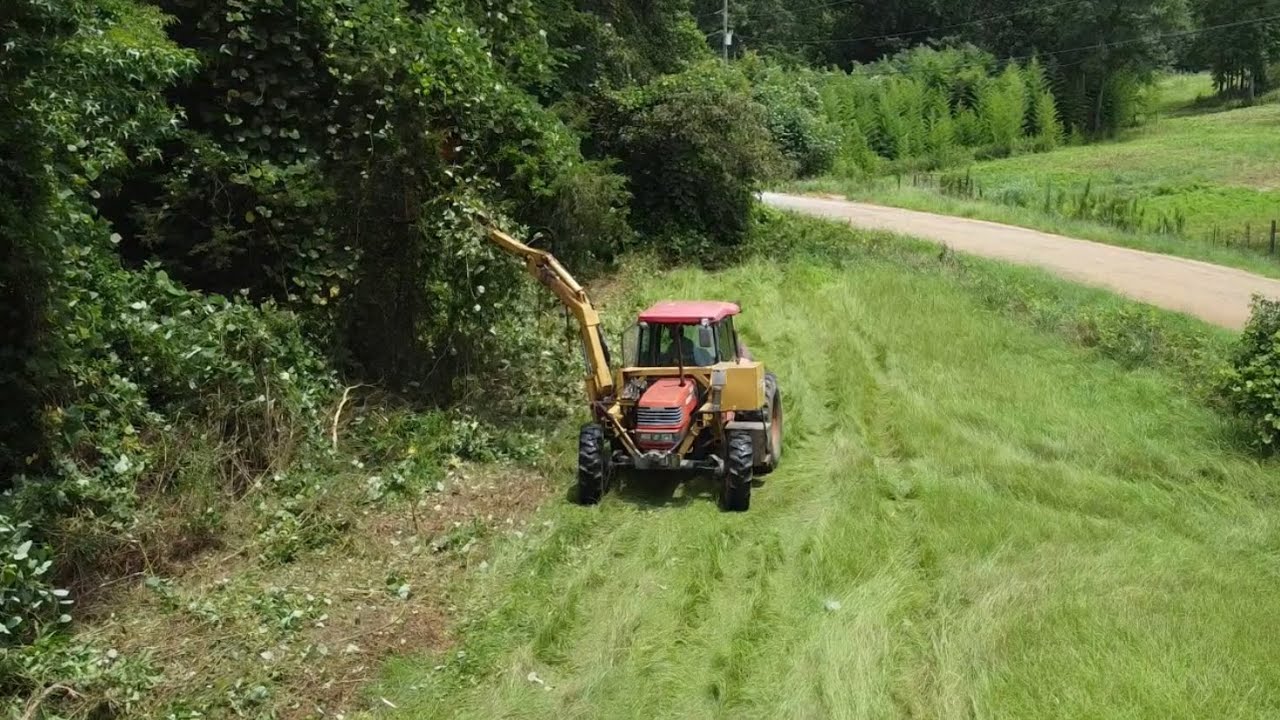 Kubota with boom cutter clearing ditch banks - YouTube