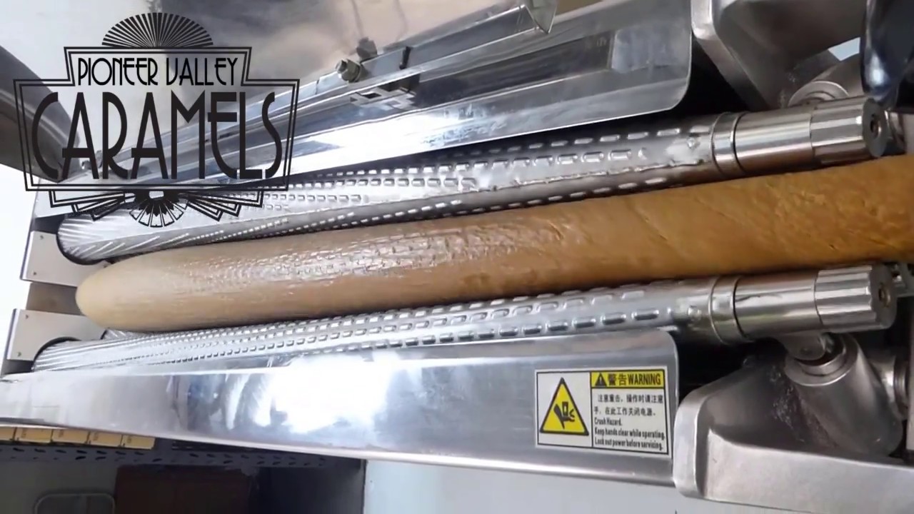Caramels being cut and double twist wrapped - YouTube